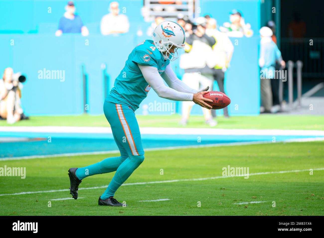 Miami Dolphins punter Thomas Morstead (4) punts the ball during an NFL football game against the ...