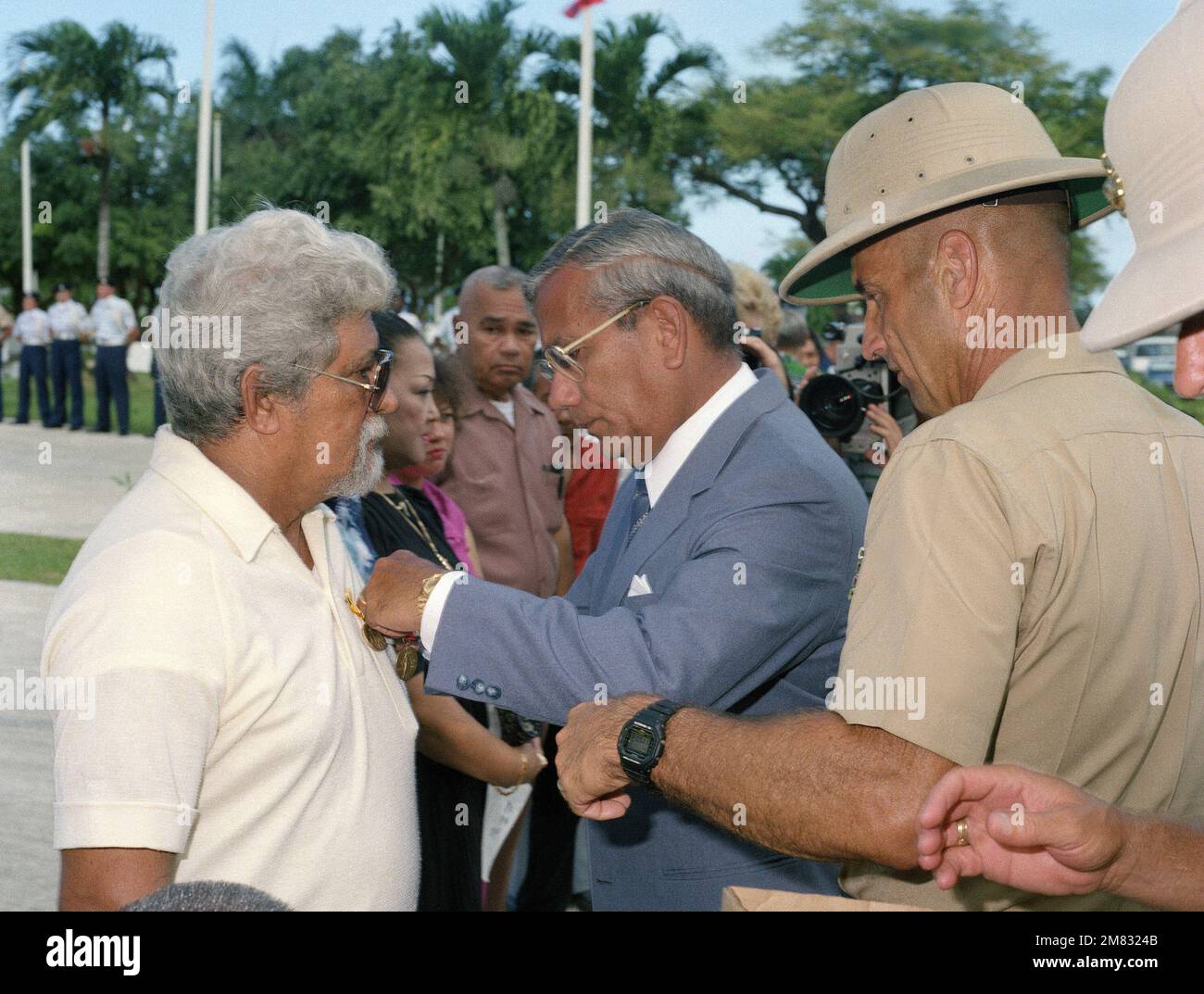 Governor Ricardo J. Bordallo of Guam pins a medal on one of the Asiatic ...