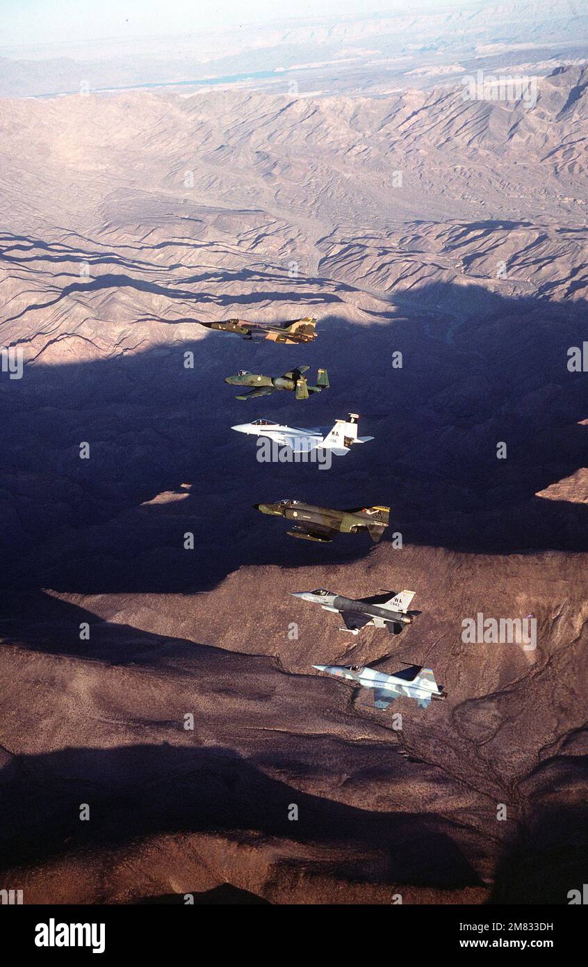 An air-to-air left side view of various U.S. Air Force Fighter Weapons ...