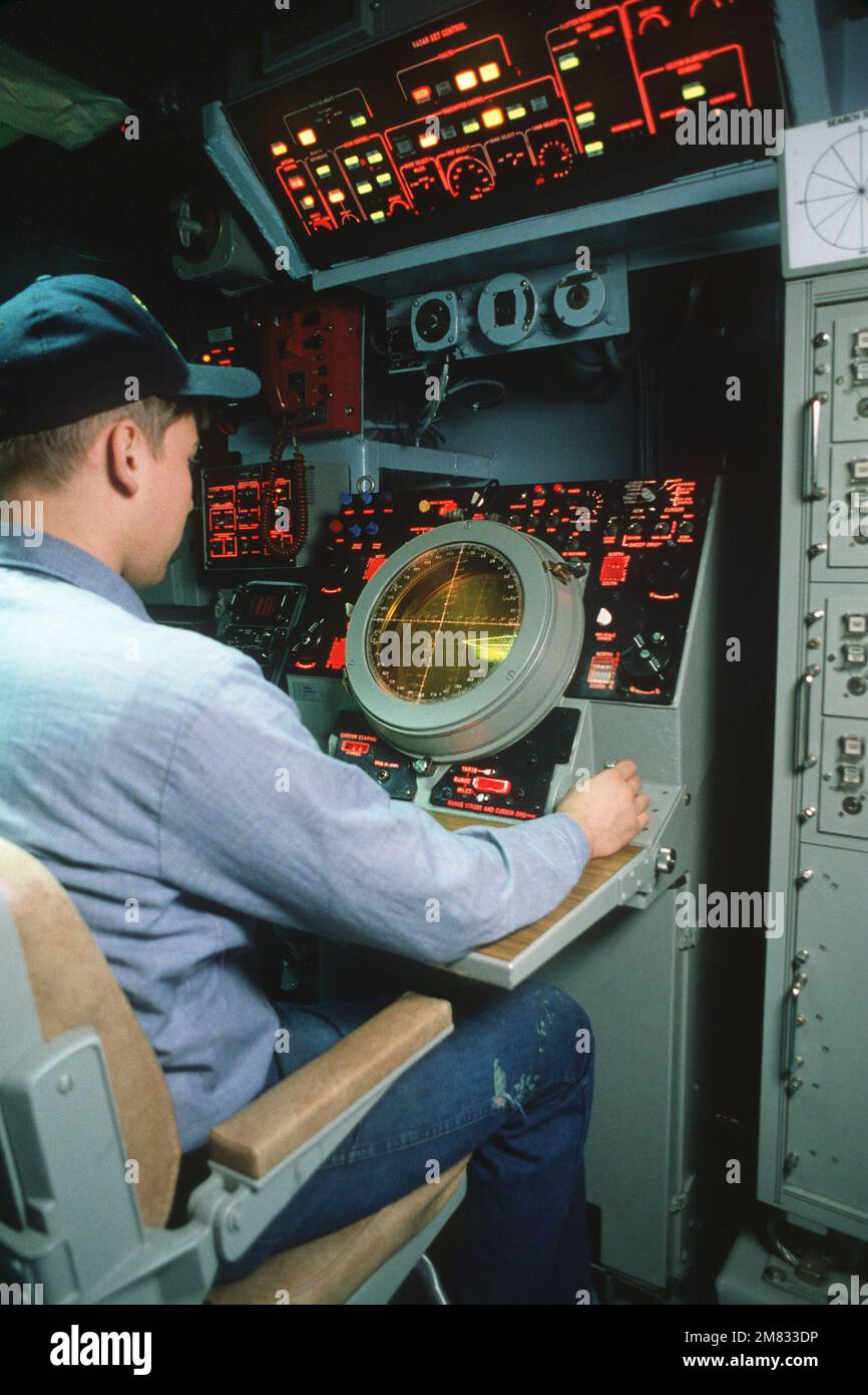 A crew member monitors the SPS-49 radar screen aboard the battleship ...