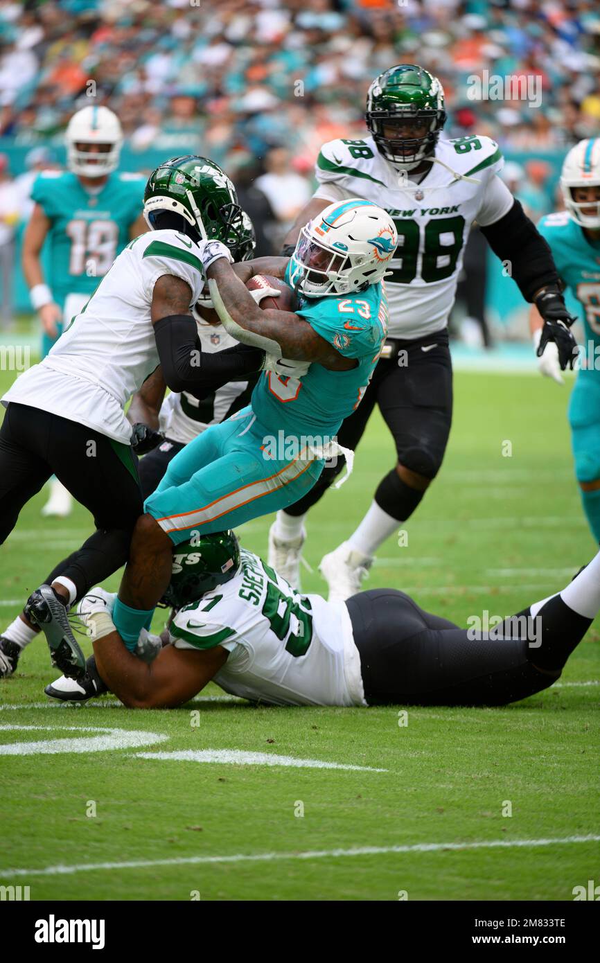 Miami Dolphins running back Jeff Wilson Jr. (23) runs with the ball and is tackled by New York ...