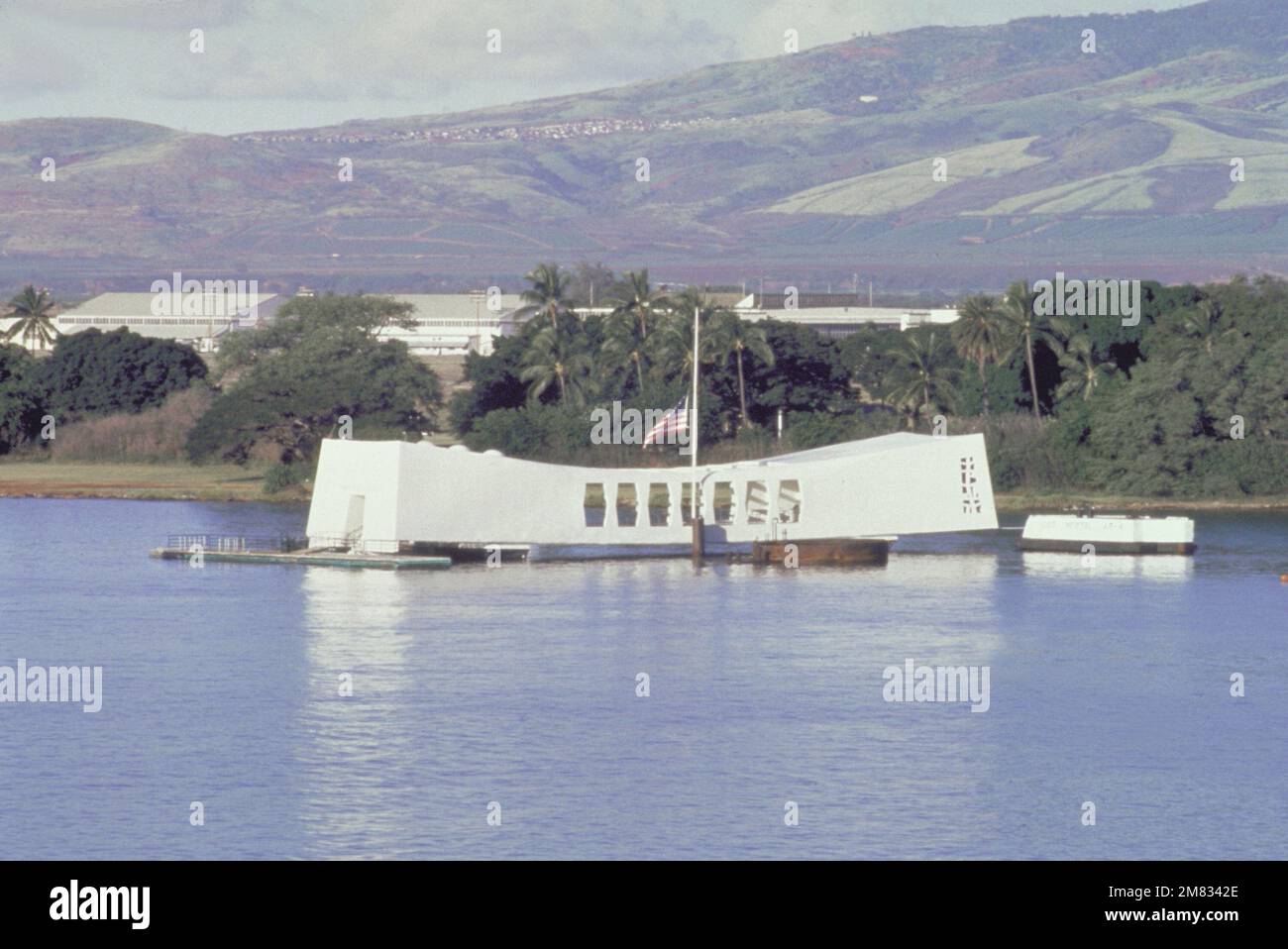 A flag flies at half-mast atop the USS ARIZONA (BB-39) Memorial to ...