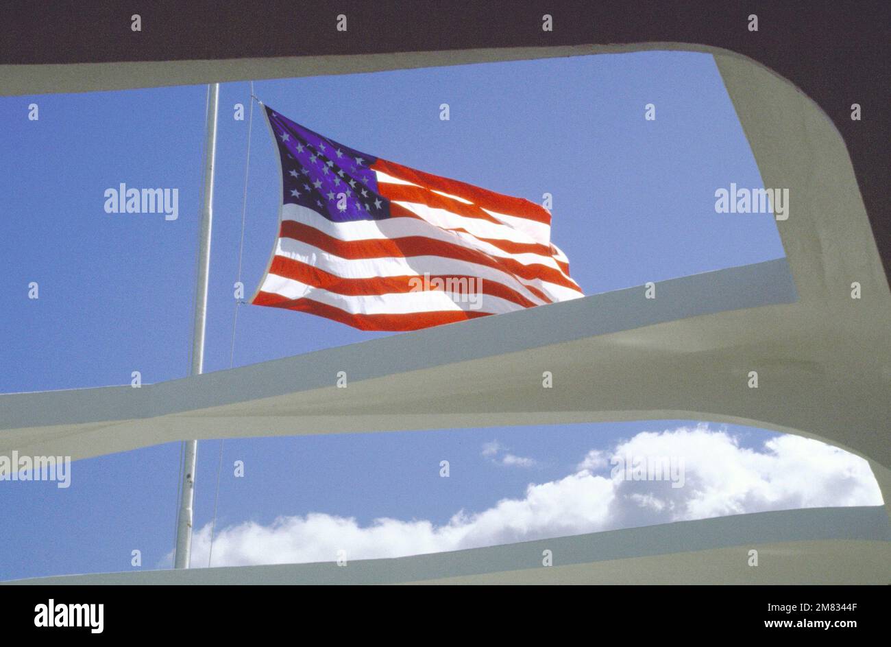 A flag flies at half-mast atop the USS ARIZONA (BB-39) Memorial to ...
