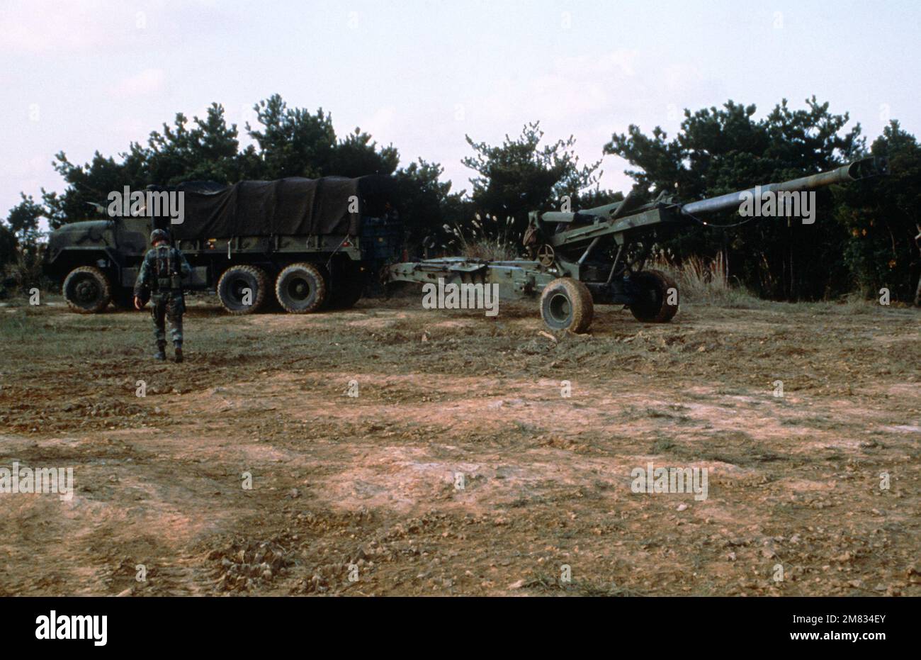 A Marine walks toward an M35 6 1/2 ton cargo truck as preparations are ...