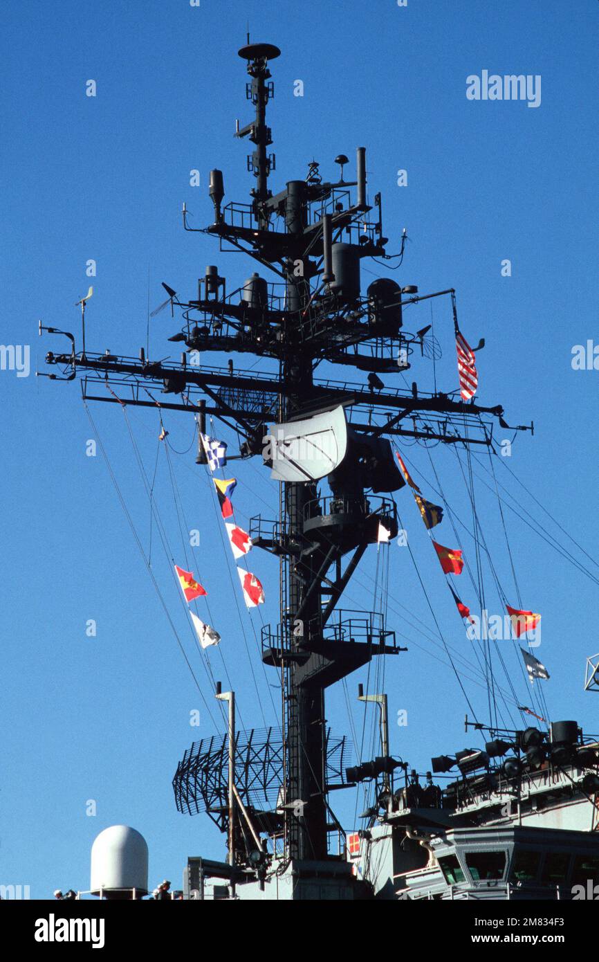 Ship's pennants ornament the mast and antenna rigging of the aircraft ...