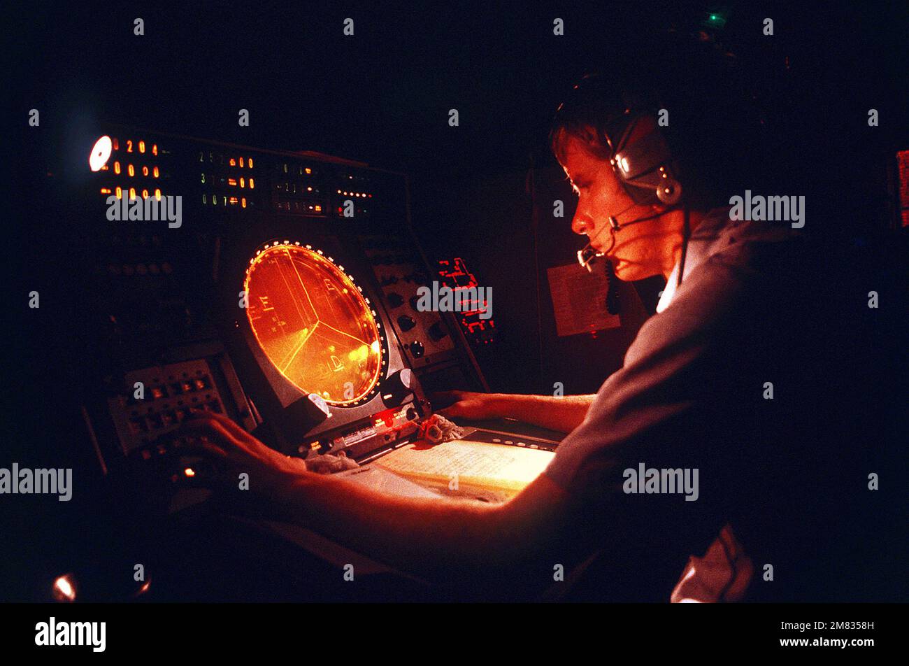 A sailor monitors a radar screen aboard the nuclear-powered aircraft ...