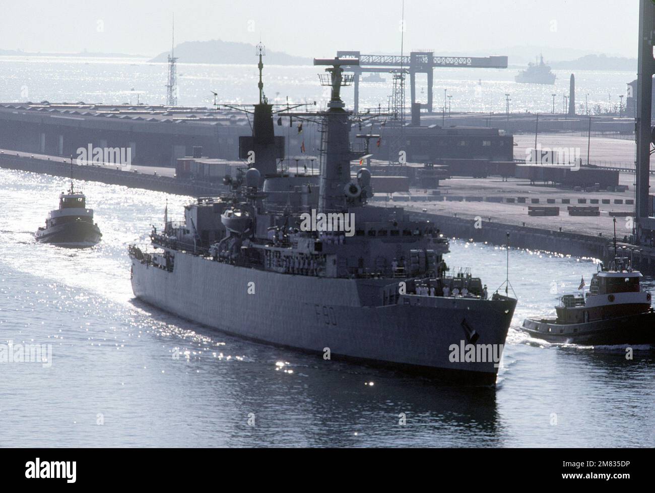 The British frigate HMS BRILLIANT (F-90) enters a port accompanied by ...