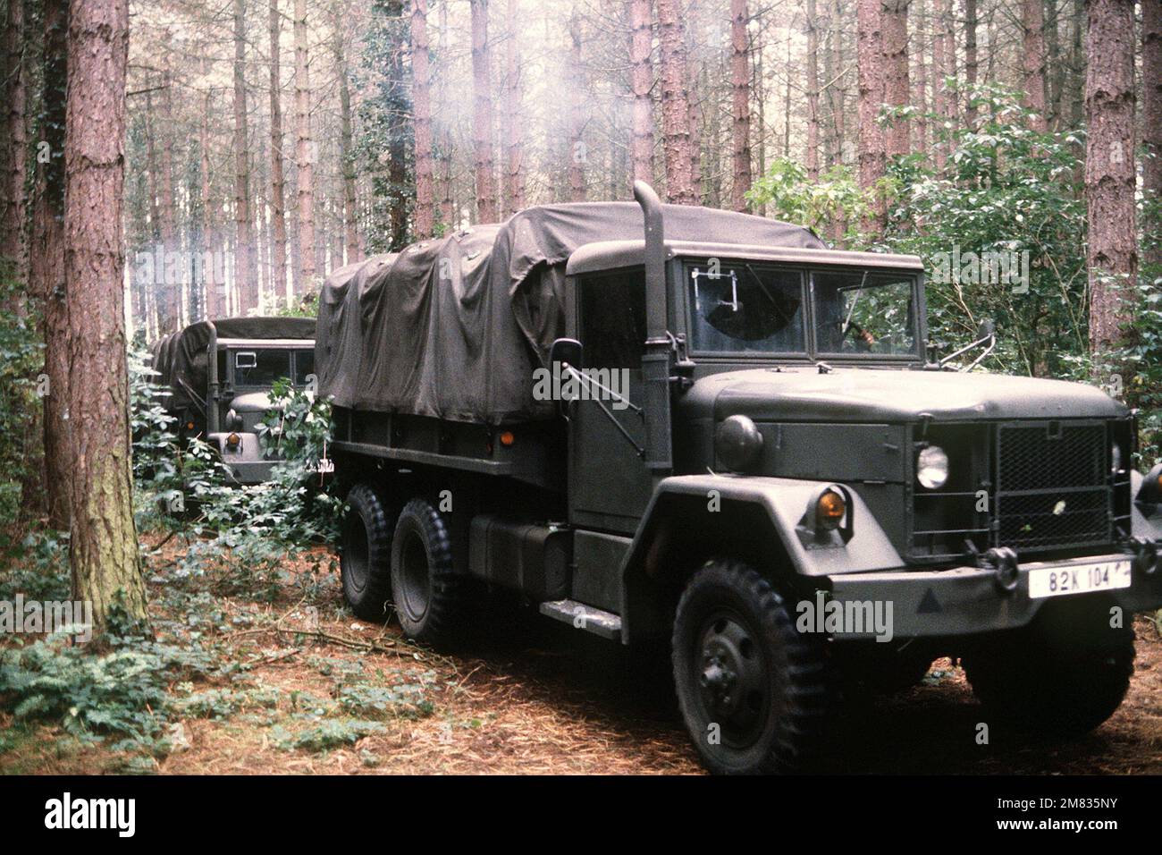 An M-35A2 2 1/2-ton cargo truck leads a supply convoy through the ...