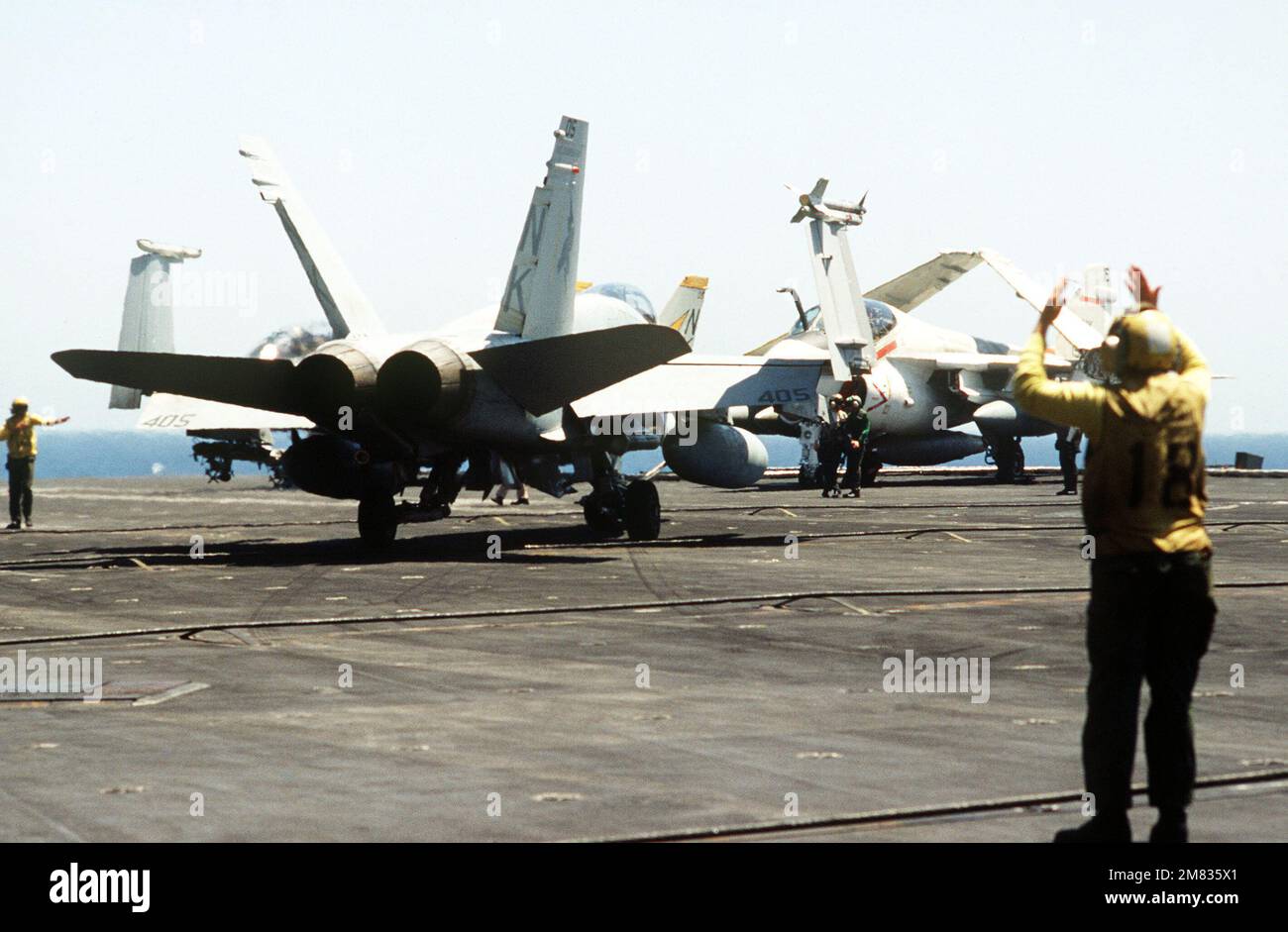 A Strike Fighter Squadron 25 F/A-18A Hornet aircraft stands by on the ...