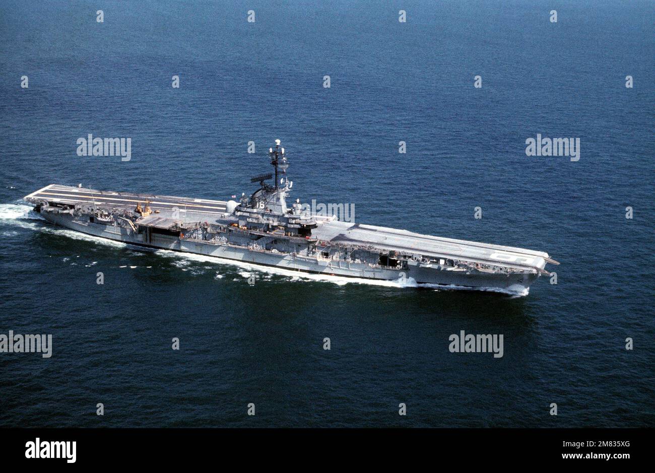 Aerial starboard bow view of the training aircraft carrier USS LEXINGTON (CVT 16) underway. Note ...