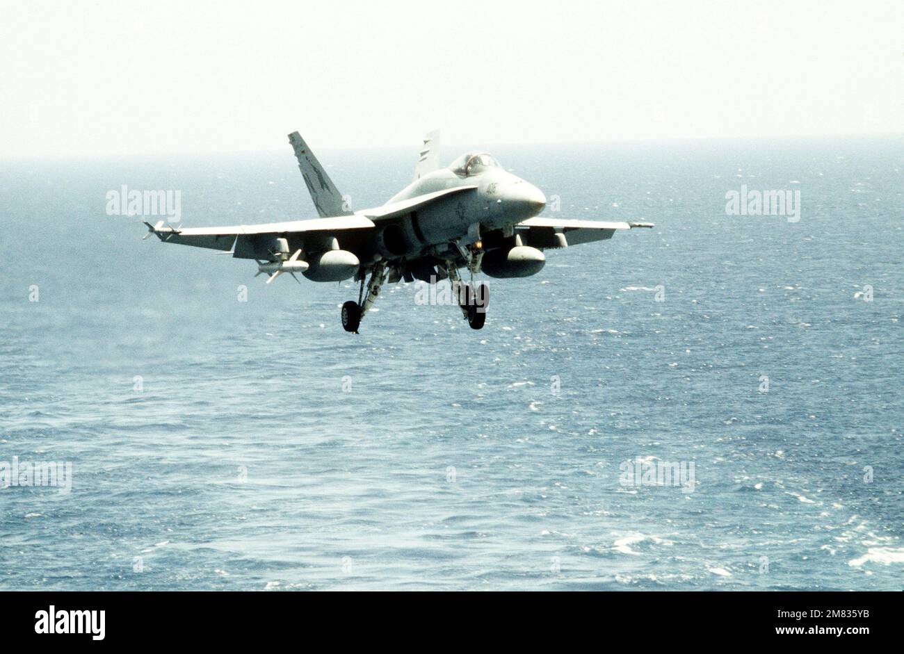 An F/A-18A Hornet aircraft from Strike Fighter Squadron 25 approaches ...