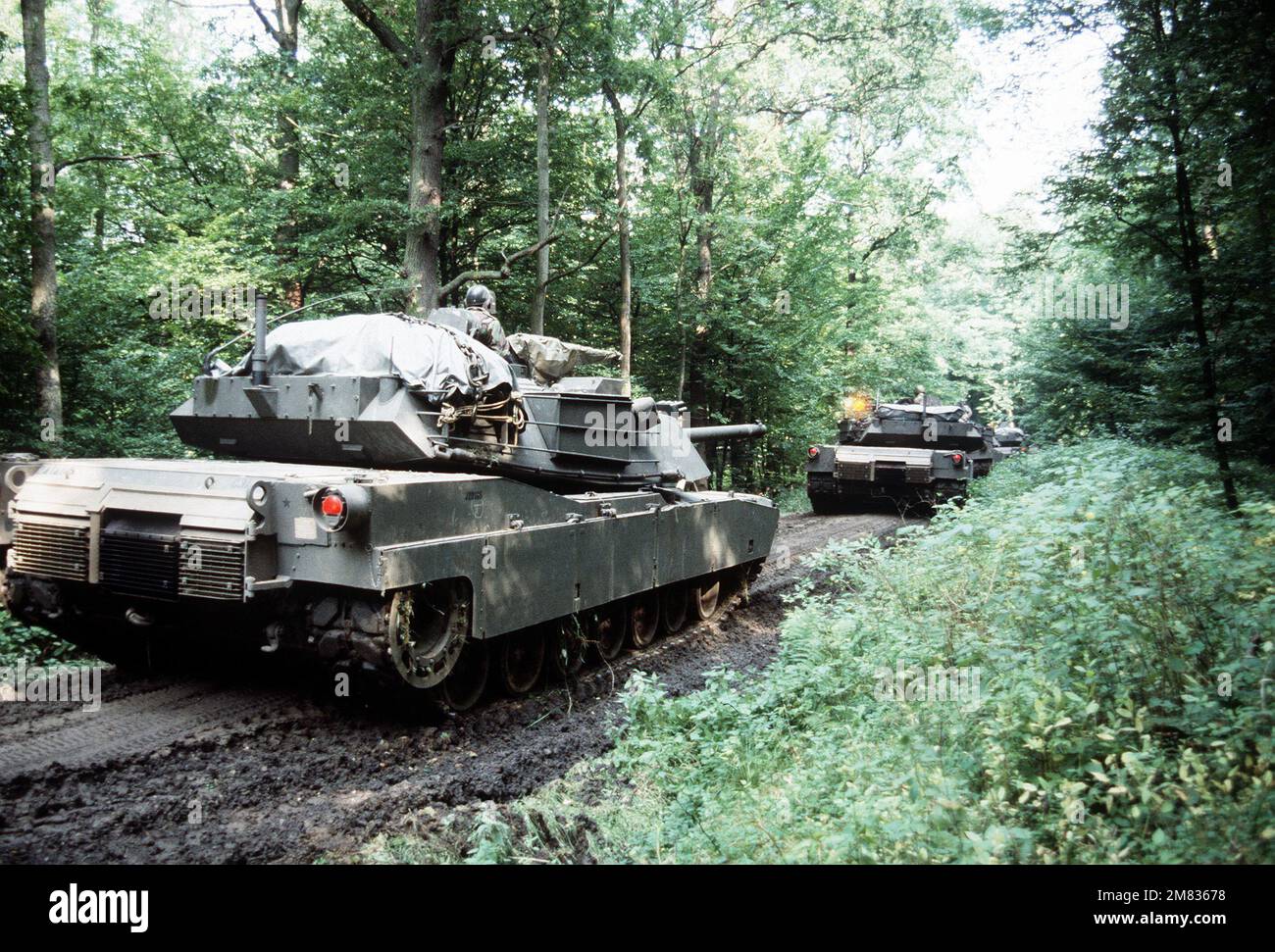 A rear view of an M1 Abrams main battle tank being secured for railroad ...