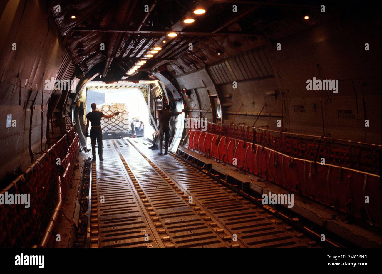 Supplies are loaded aboard a C-141 Starlifter aircraft. The supplies ...
