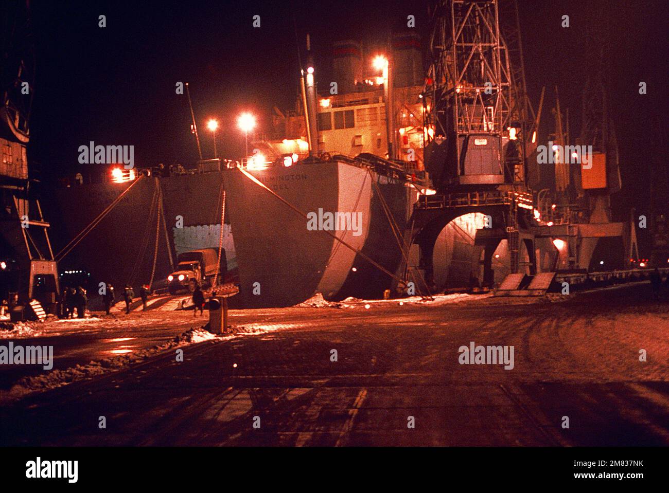 An M-35 2 1/2 ton cargo truck is offloaded at night from the vehicle ...