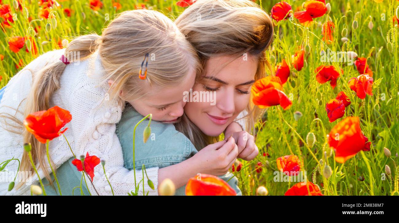 Mother and daughter on the poppies field background. Spring family ...