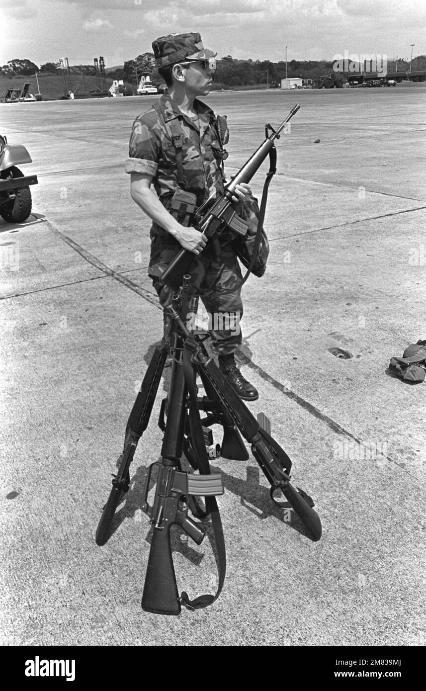 A soldier, armed with an M-16A1 rifle, stands ready during exercise ...