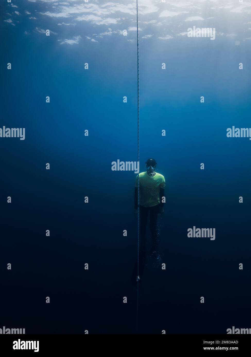 October 03, 2022. Amed, Indonesia. Men in wetsuit with fins training ...