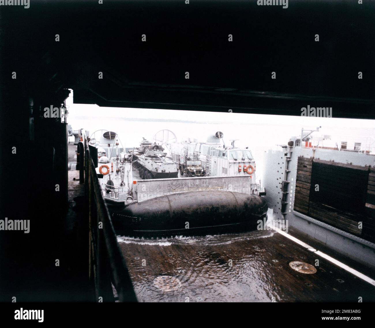 A landing craft air cushion (LCAC 001) enters the well deck of the dock ...