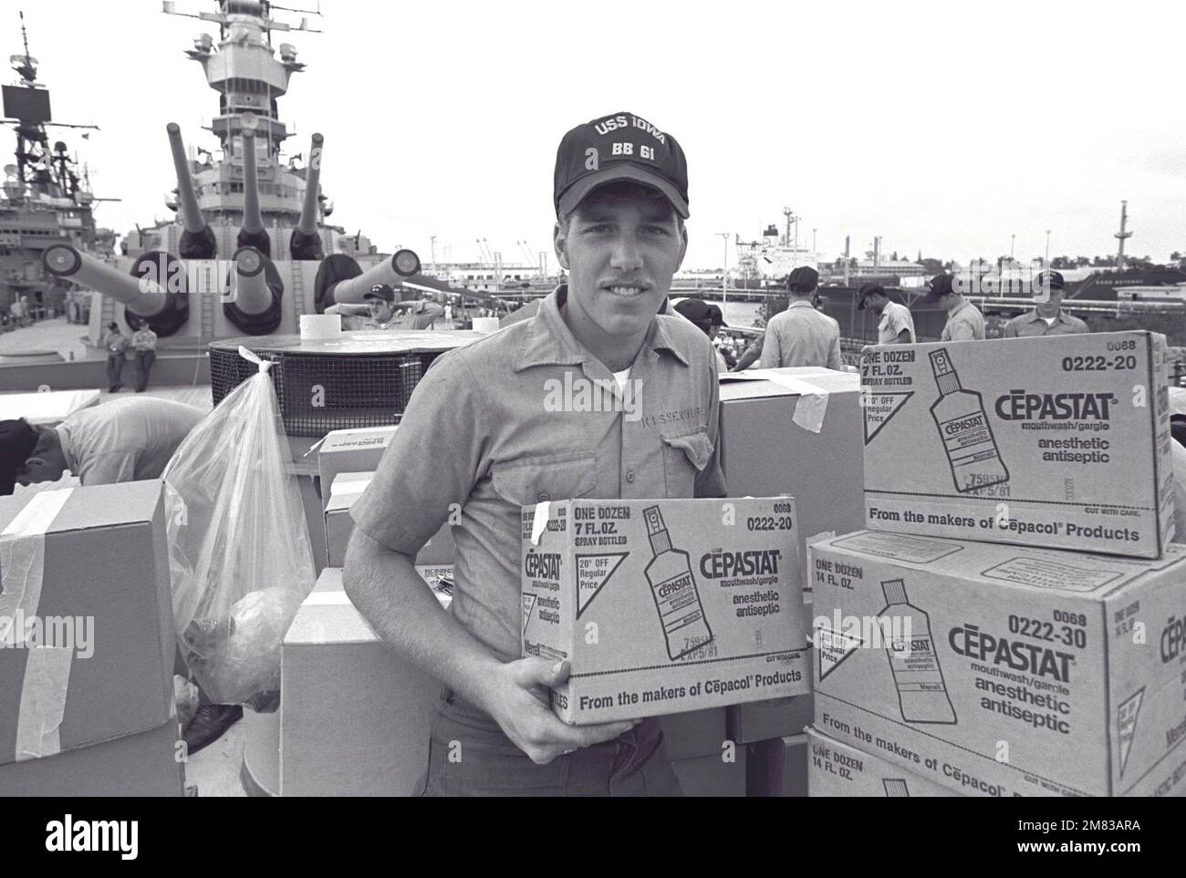 Crew members load Project Handclasp materials aboard the battleship USS ...