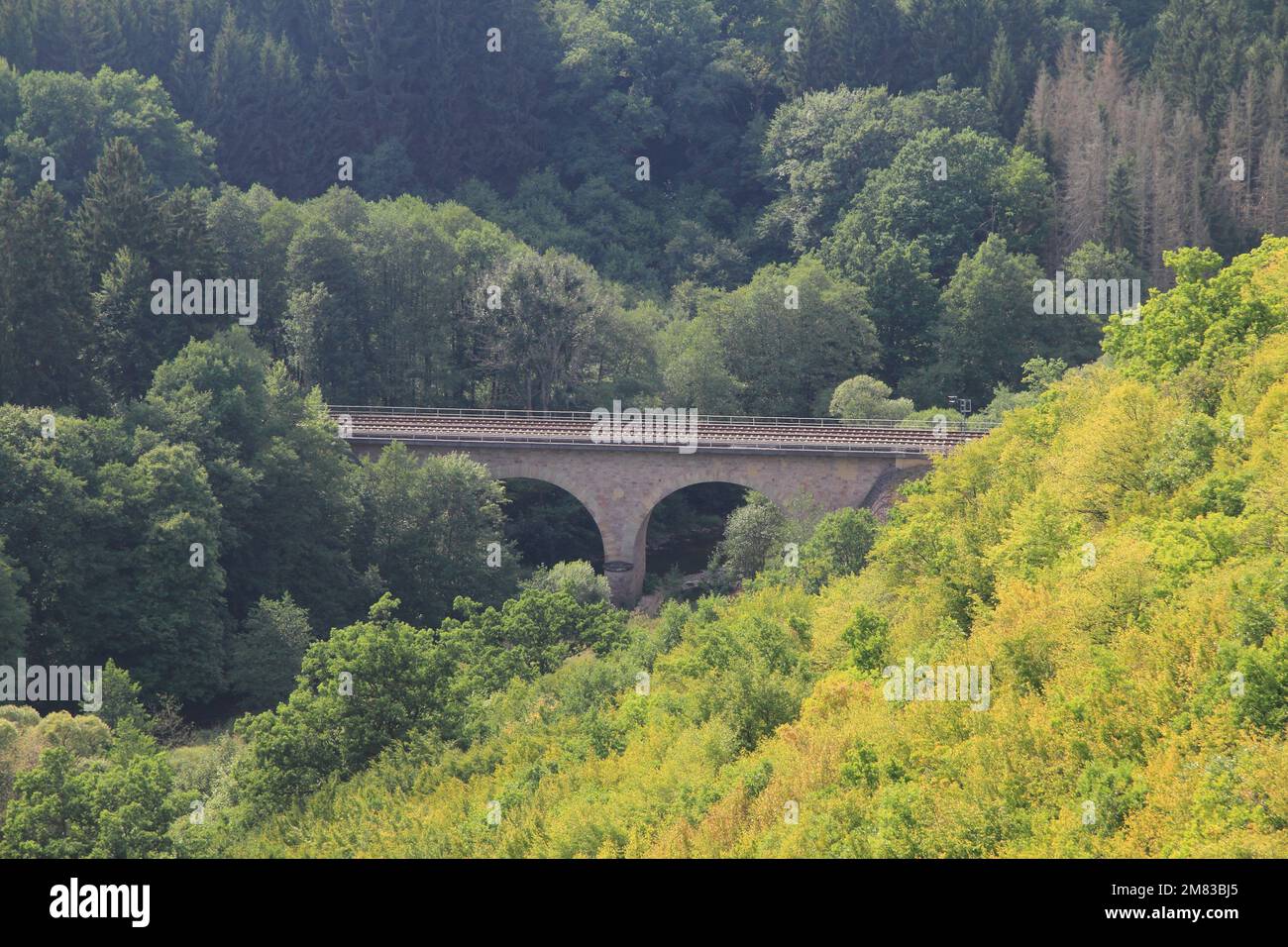 built a stone arch bridge over a green valley Stock Photo - Alamy
