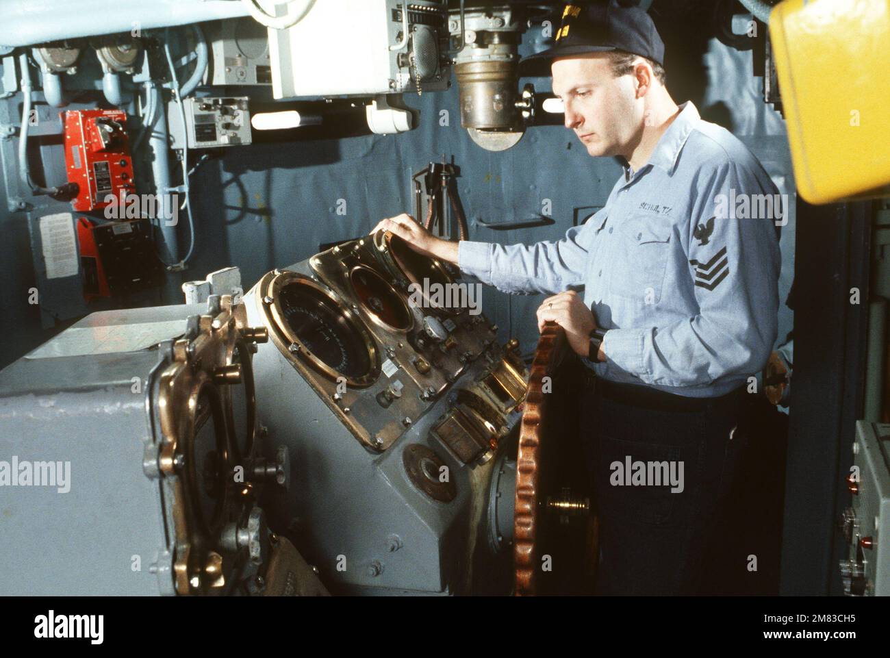 Quartermaster 1ST Class Ronald Schultz operates the helm of the ...