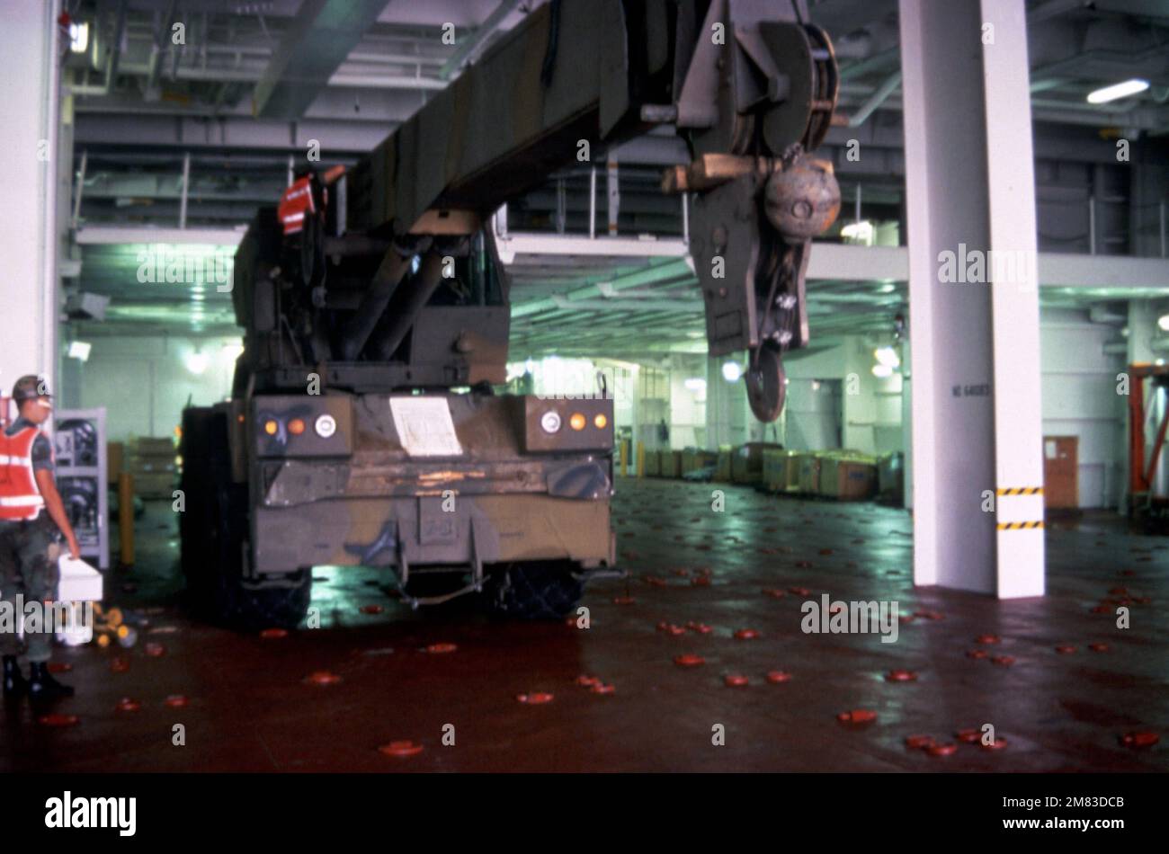 A 6th Marine Amphibious Brigade mobile crane is maneuvered into a ...