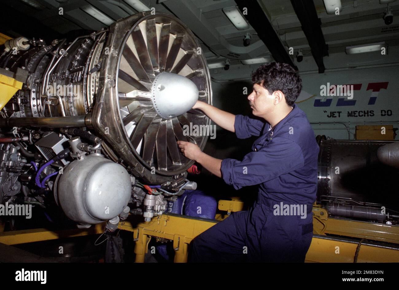 Aviation Machinist's Mate Second Class Corona checks jet engine blades ...