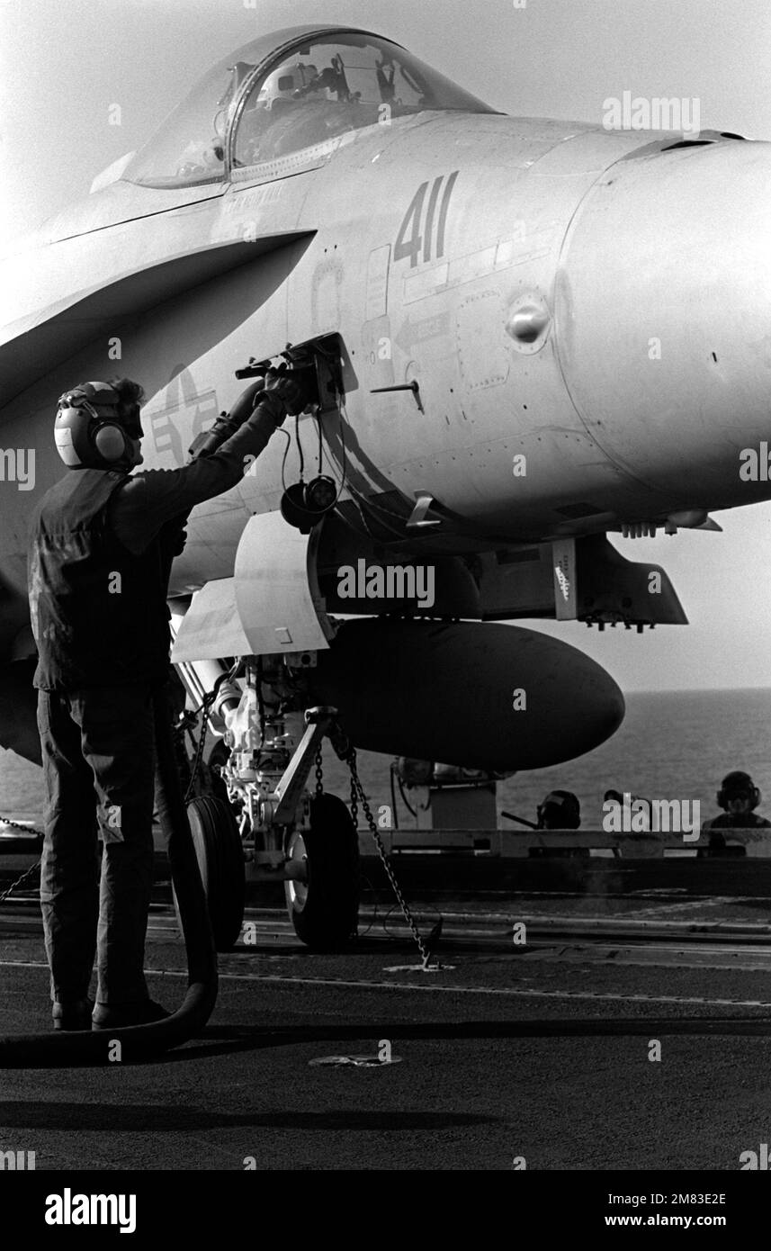 An F/A-18 aircraft from Strike-Fighter Squadron 25 (VFA-25) is fueled ...