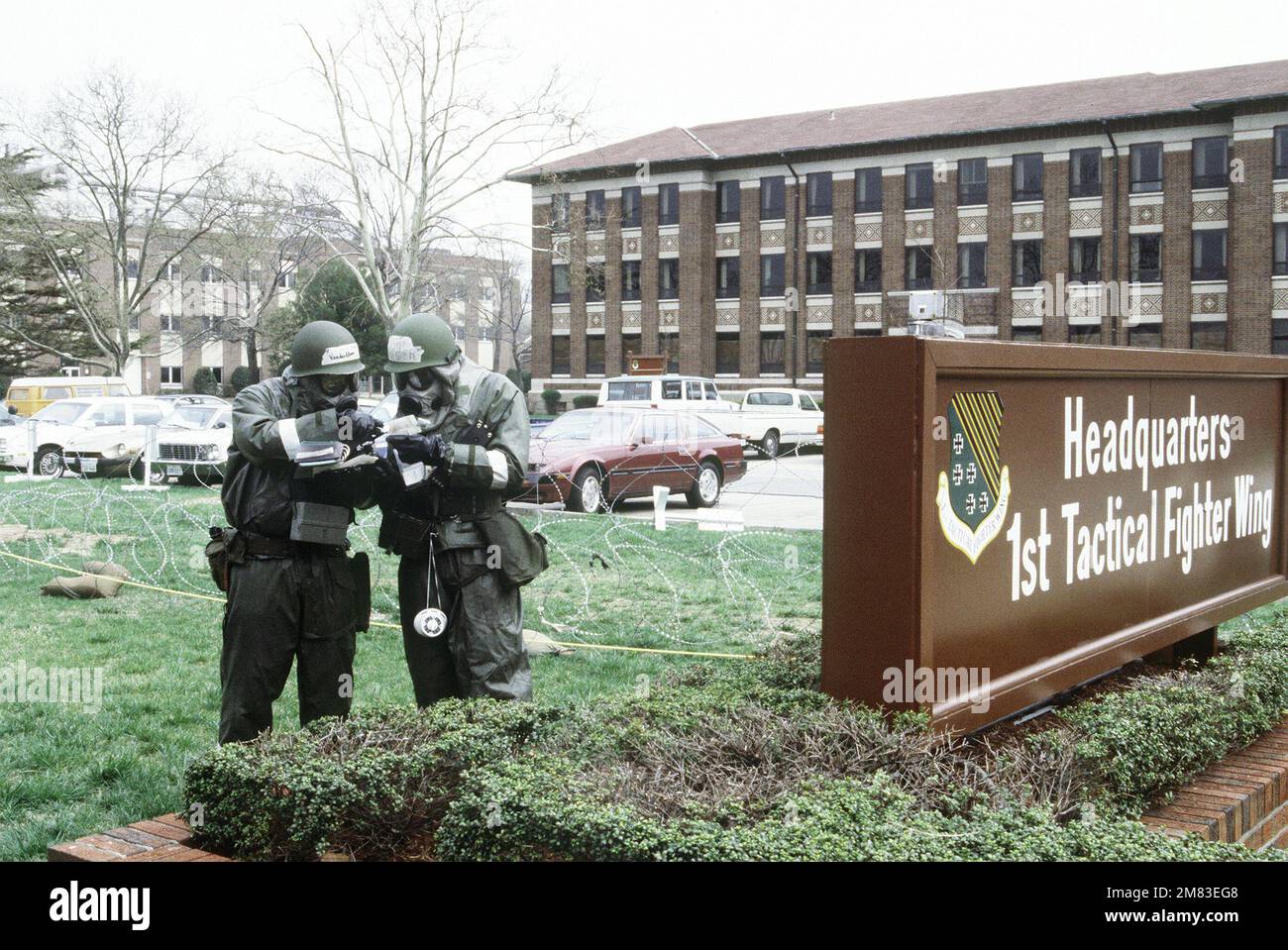 Perimeter guards wearing biological/chemical protective gear man their ...