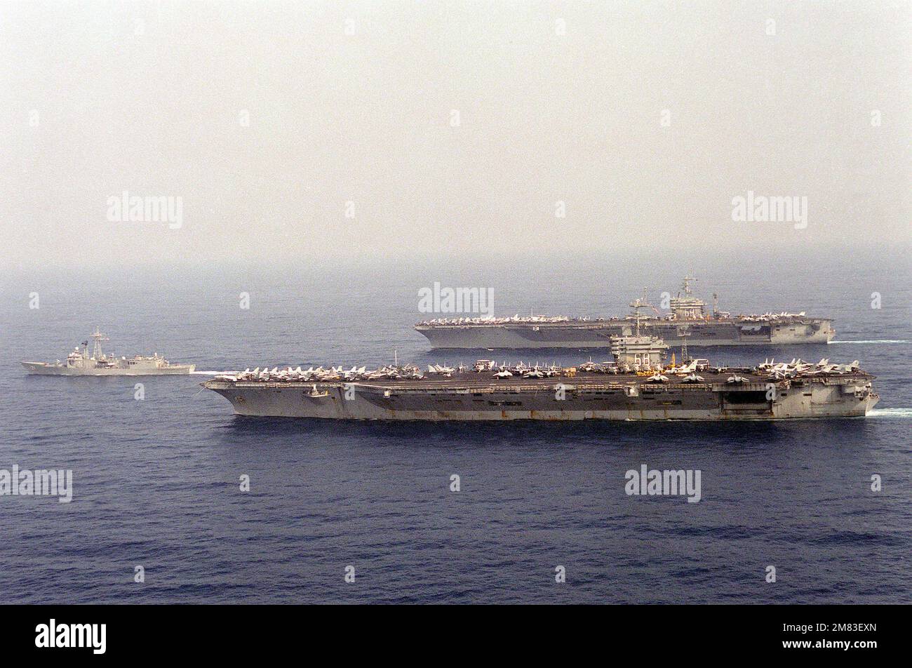 A port beam view of the nuclear-powered aircraft carriers USS NIMITZ ...