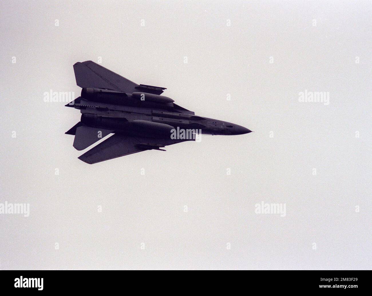 An air-to-air left side view of an inverted F-14A Tomcat aircraft ...