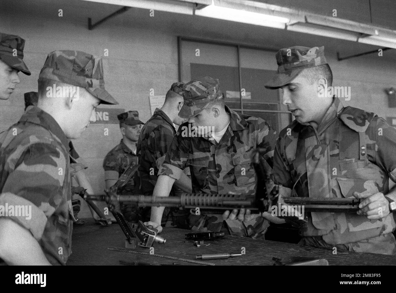 Members of the Navy ROTC examine an M-60 machine gun during a visit to ...