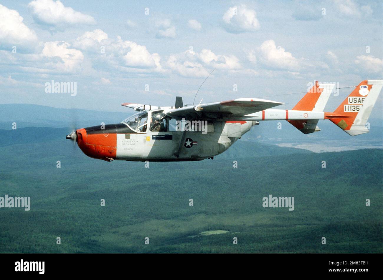 An air-to-air left side view of an O-2A aircraft from the 25th Tactical ...