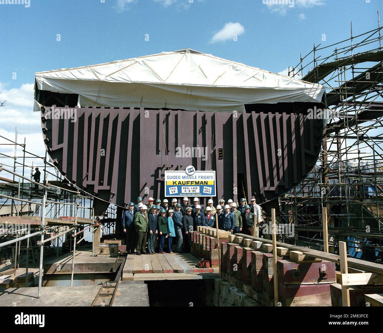 Officials of Bath Iron Works and Navy official gather for a group ...