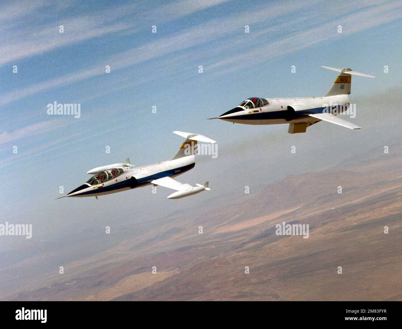 An air-to-air left side view of two NASA F-104 Starfighter aircraft in ...