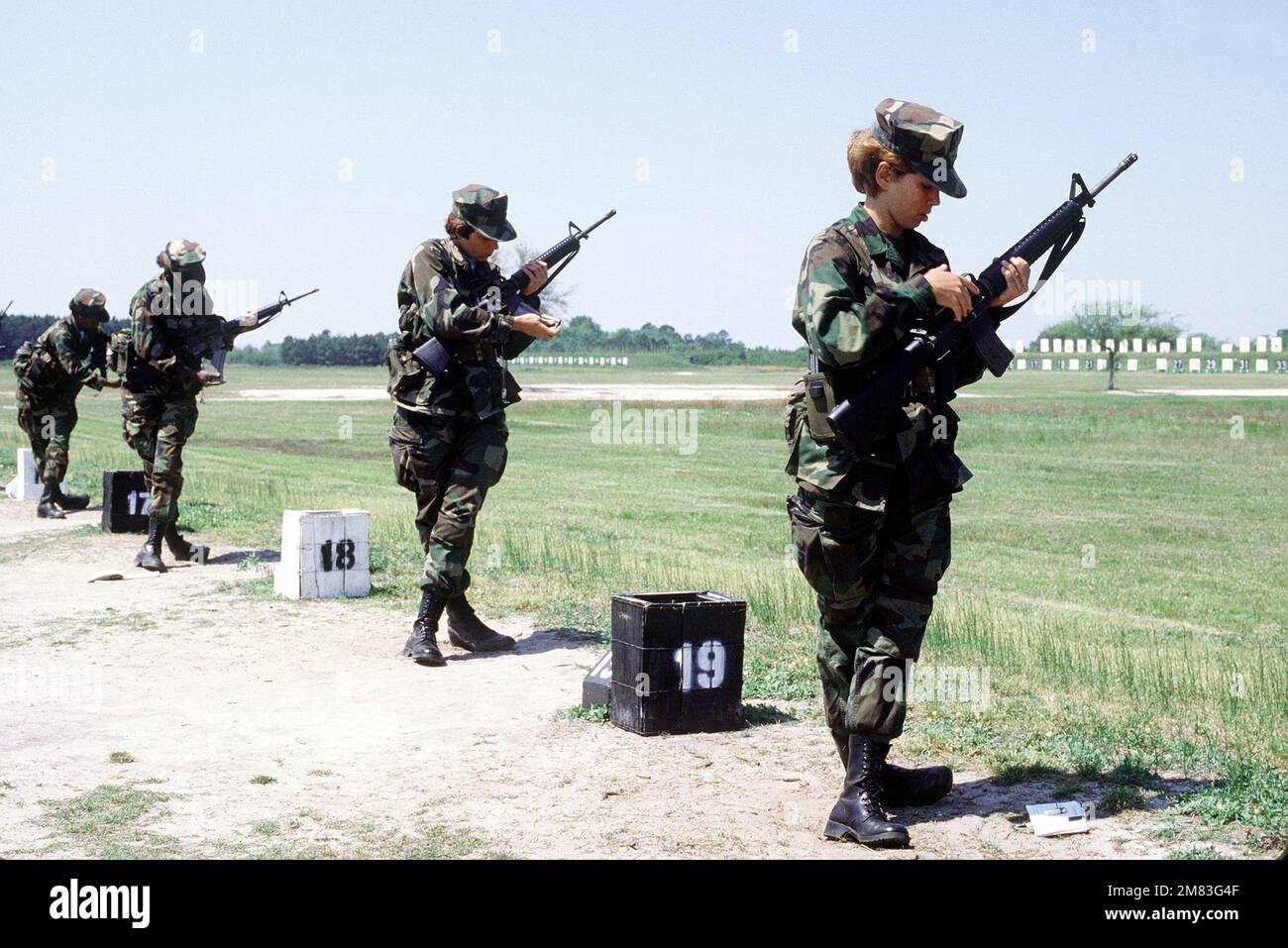 Female Marine recruits prepare to fire M-16A2 refiles during small arms ...