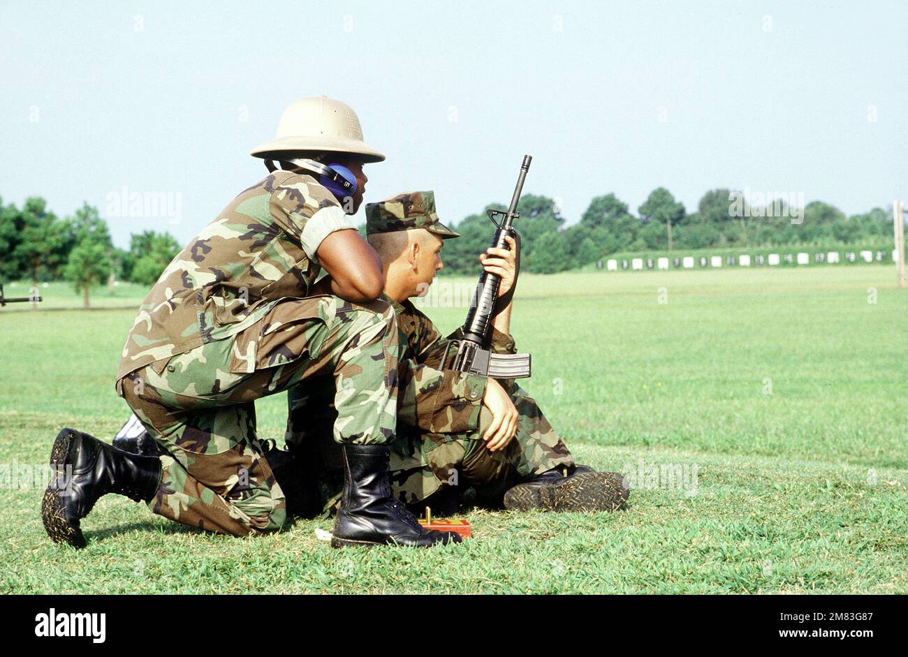 A drill instructor explains the correct method for firing an M-16A2 ...