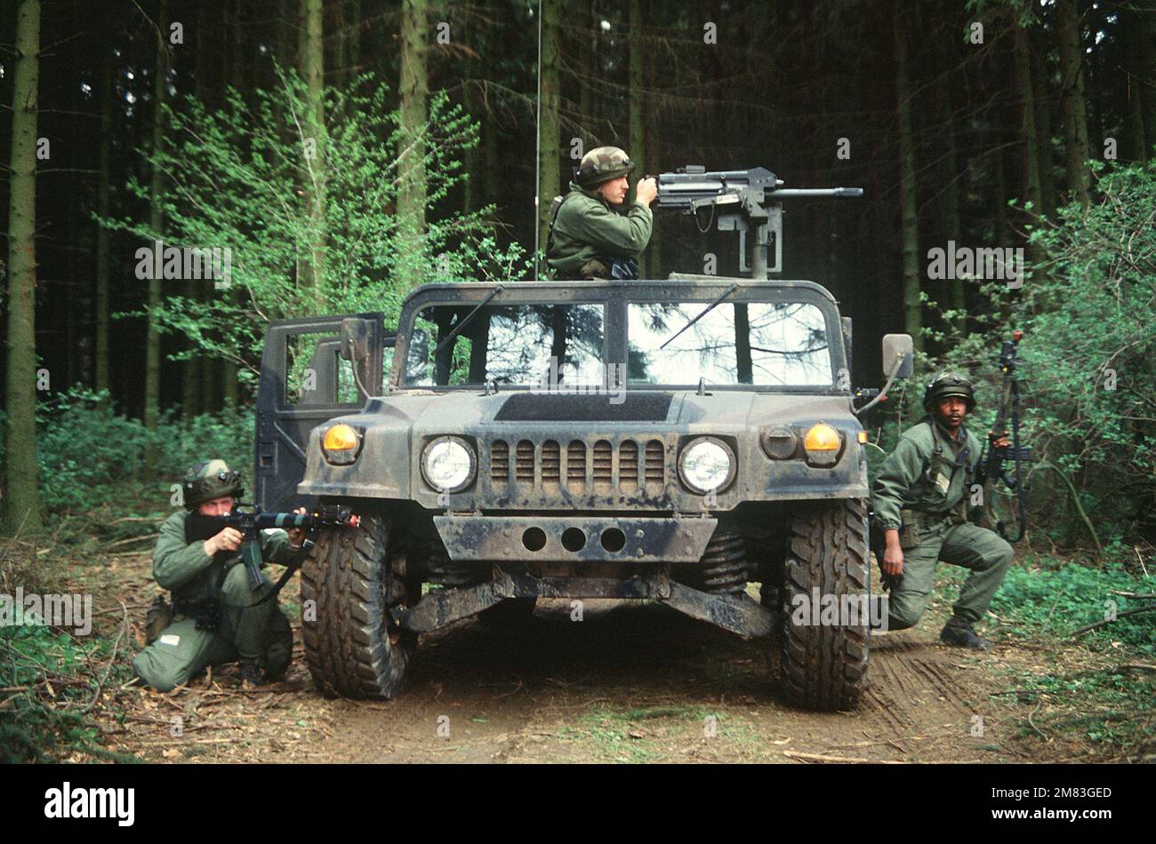 A security policeman aims a Mark 19 40mm grenade launcher atop an M-998 ...