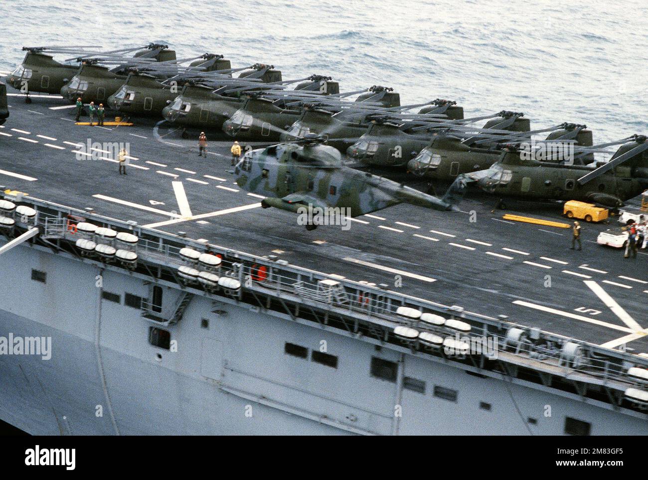An HH-3 Jolly Green Giant helicopter lands aboard the amphibious ...