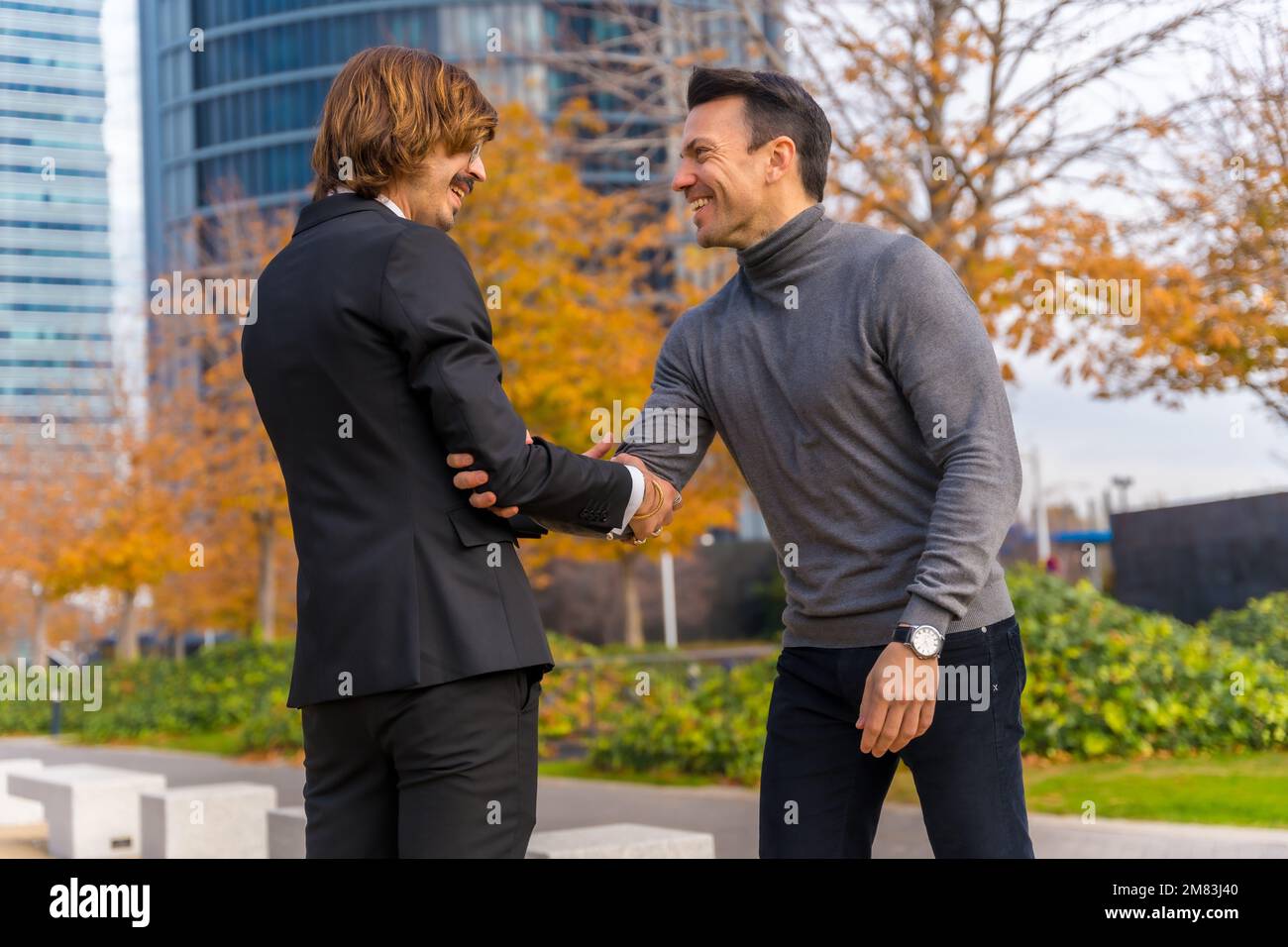 A scenic view of two caucasian businessmen greeting each other outside ...