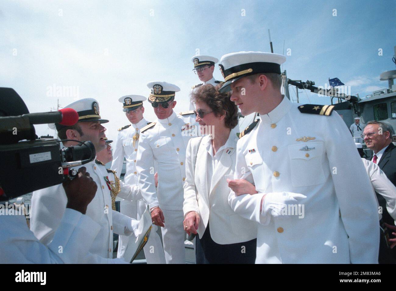 A motion picture cameraman films the arrival of distinguished guests at ...