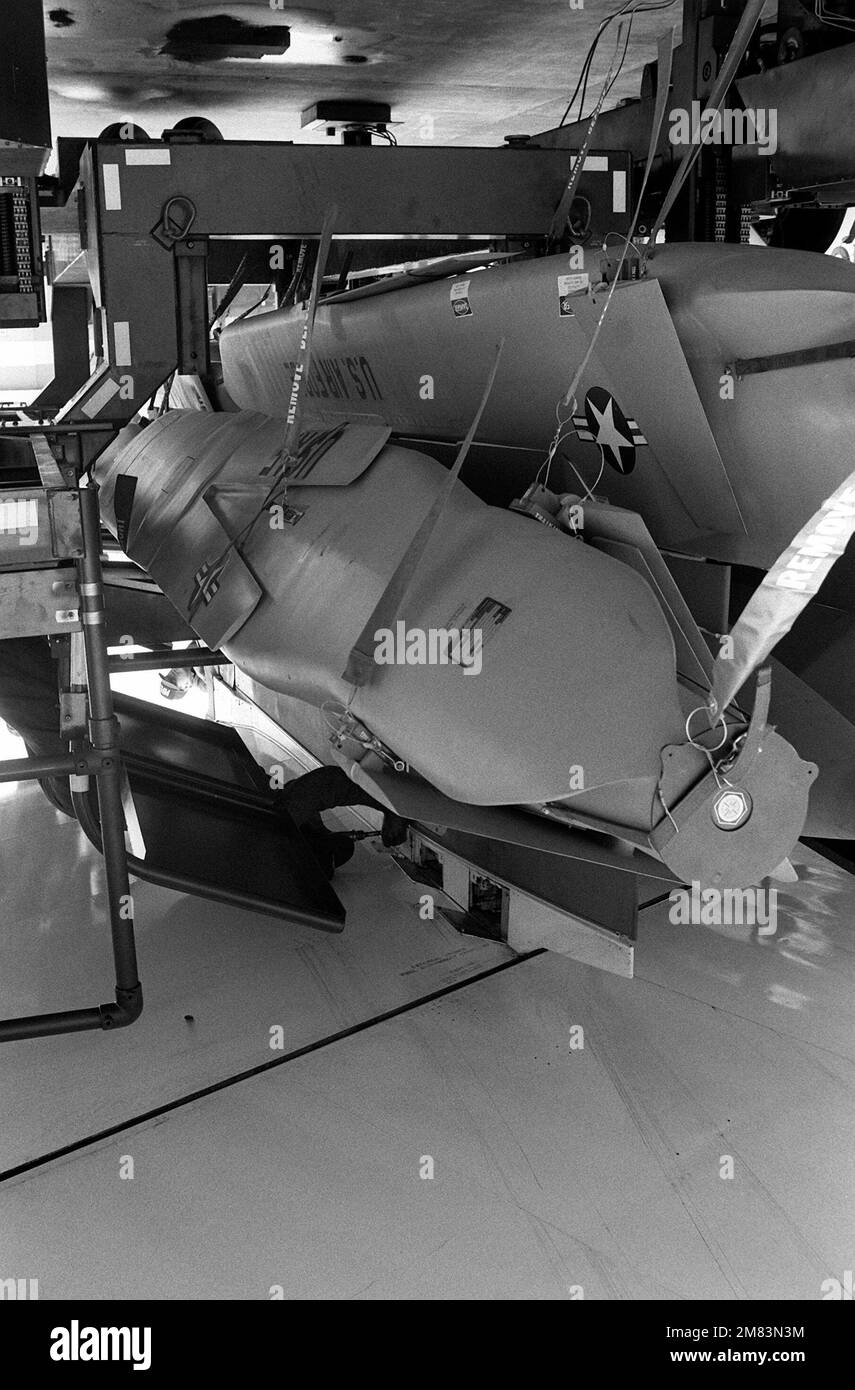 An airman from the 416th Munitions Maintenance Squadron tightens a ...