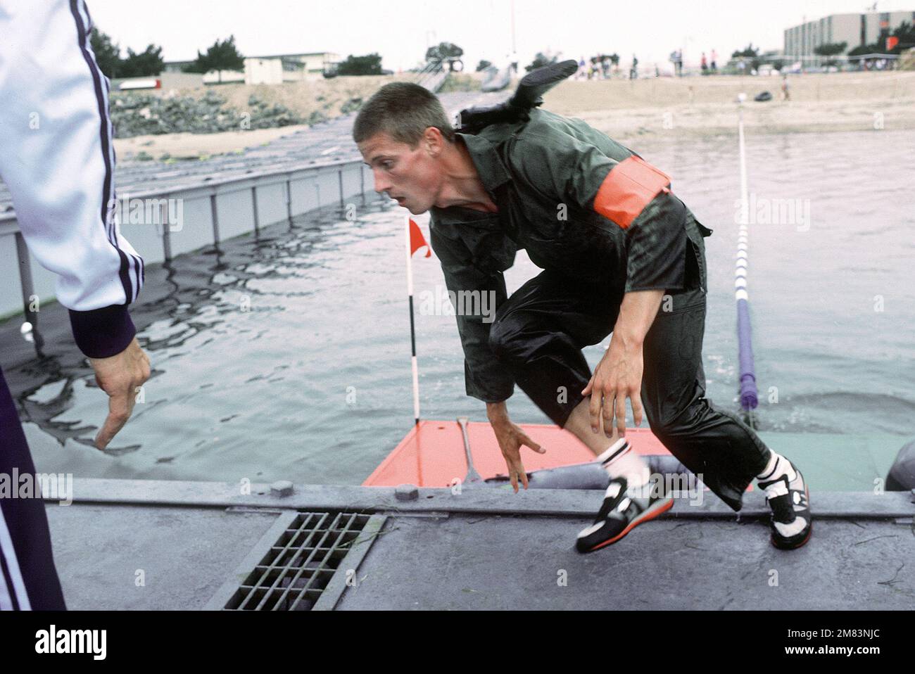 A contestant begins to run after completing the rafting phase of an ...