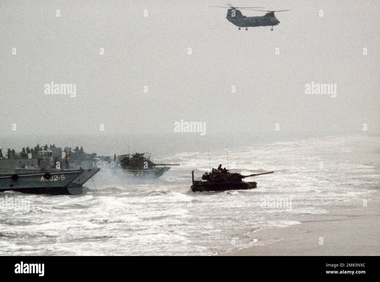 An M-60 tank is driven ashore from an Assault Craft Unit 2 (ACU-2) LCM ...