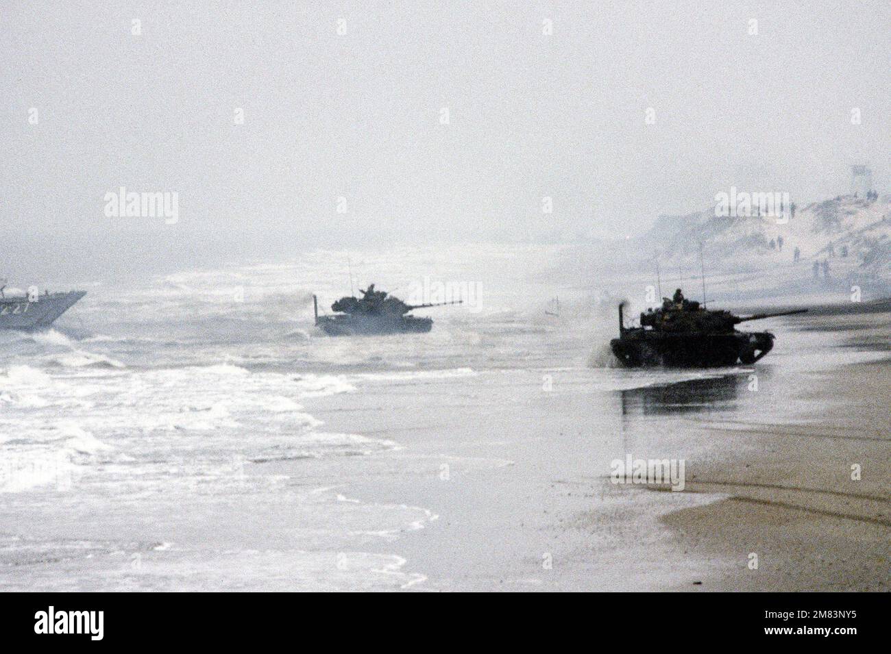 M-60 tanks are driven ashore from landing craft at Onslow Beach during ...