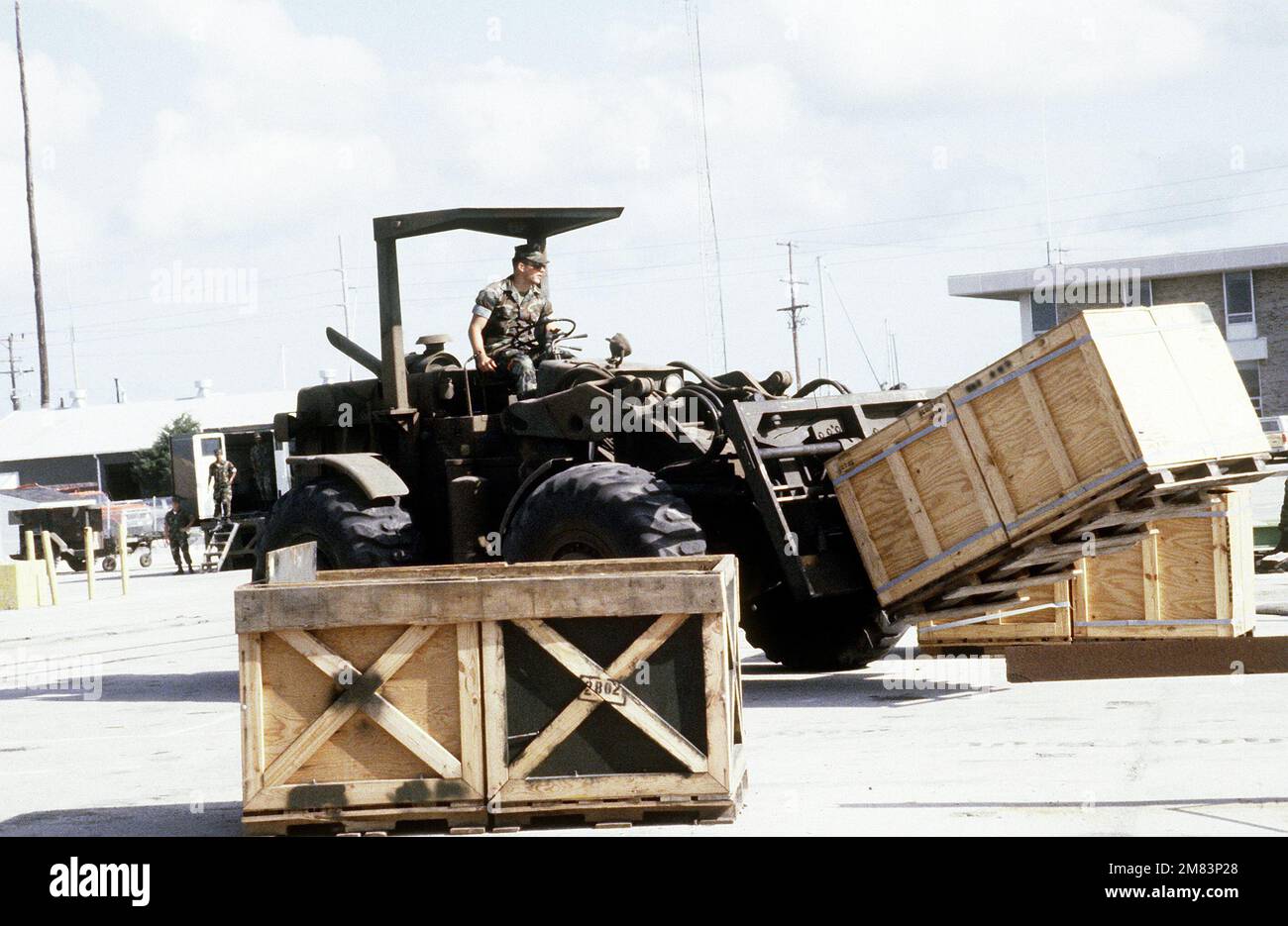 A marine uses a TEREX 72-31 rough terrain forklift to move crates of ...
