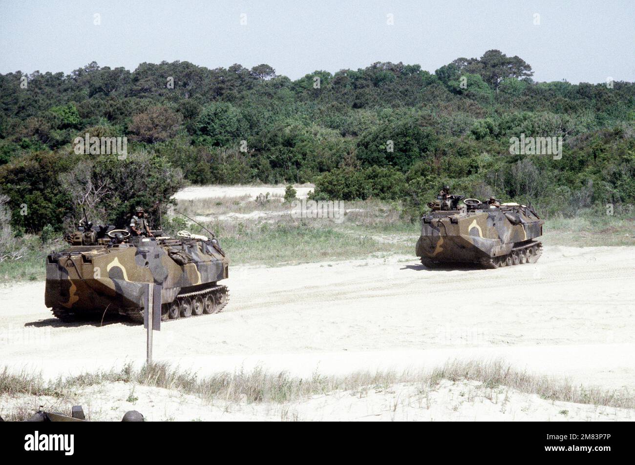 Two LVTP-7 tracked vehicles underway during exercise Solid Shield '85 ...