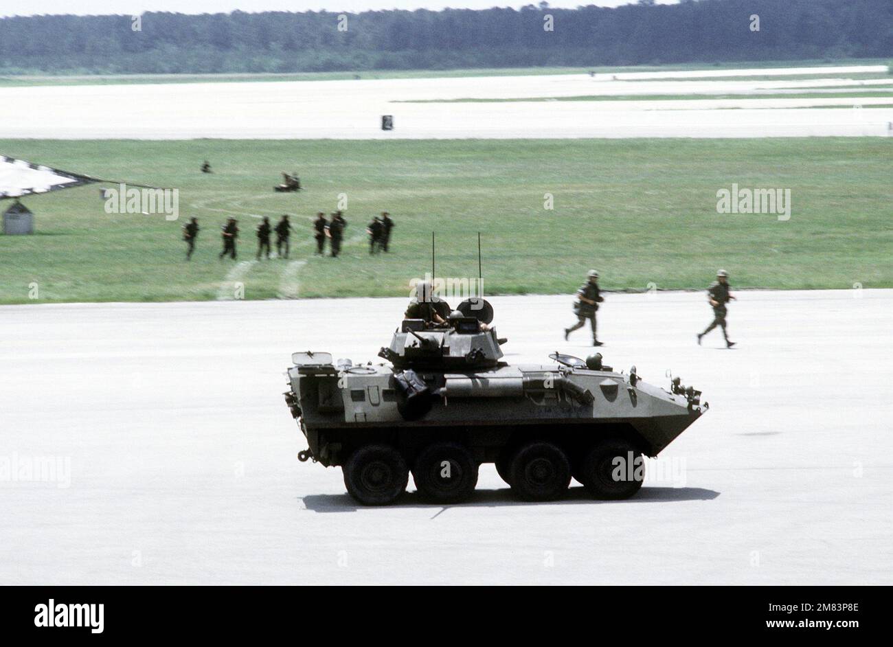 An LAV-25 light armored vehicle followed by Marines during exercise ...