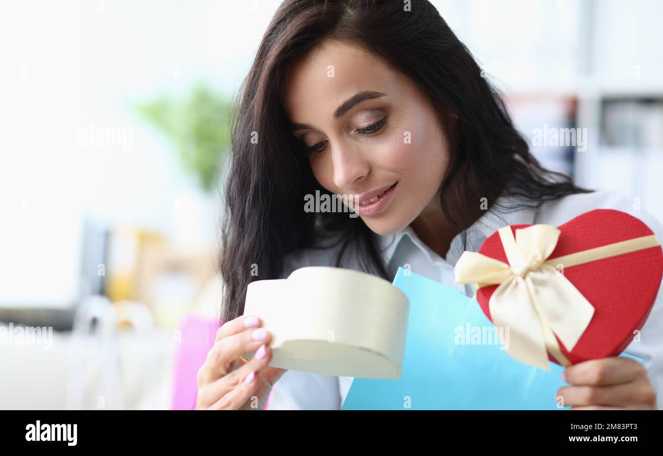 Beautiful woman opens gift box. Gift from a loved one Stock Photo - Alamy