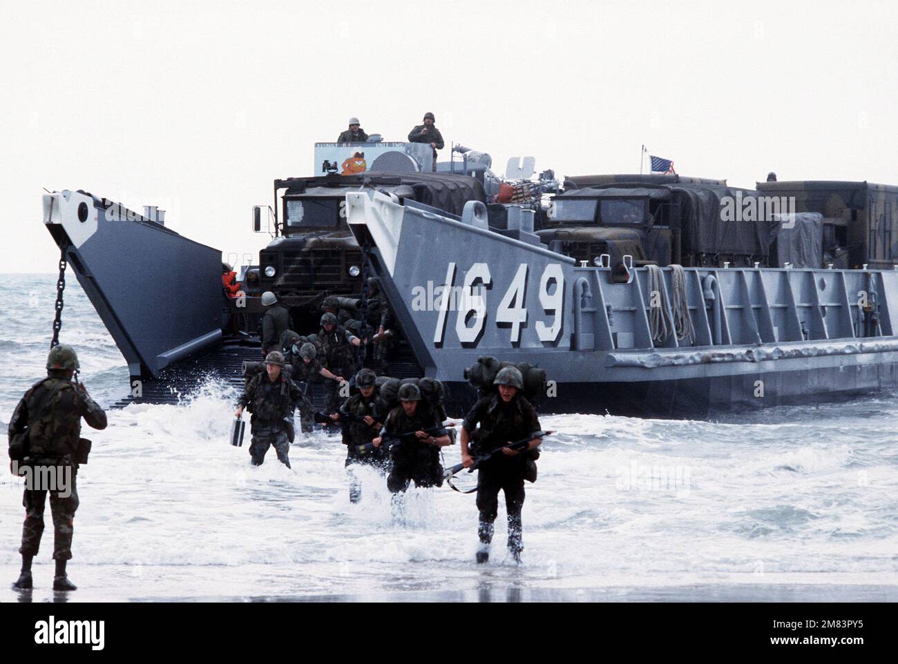 Marines exit from the utility landing craft LCU-1649 at Onslow Beach ...